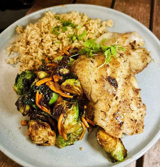 Perfectly grilled grouper paired with rice and Brussels sprouts proves healthy eating doesn't have to taste like punishment.