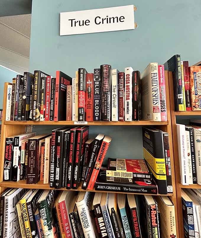 True crime shelves packed tighter than a courtroom during a celebrity trial, mysteries waiting to be solved.