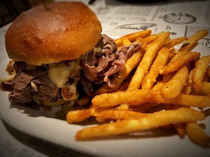 The Lumberjack Burger towers with meat and cheese, making you wonder if utensils are just a polite suggestion here.