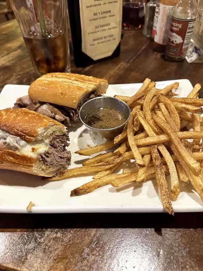 Lamb French dip so tender it practically dissolves, served with fries that could convert any potato skeptic instantly.