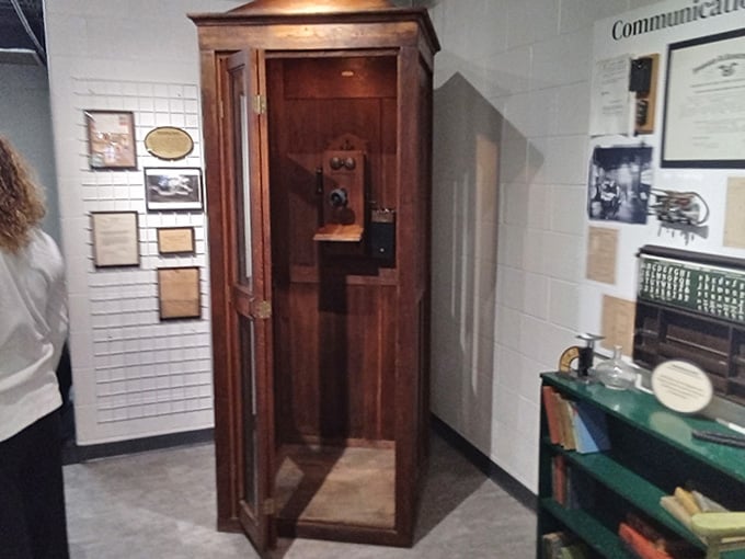 An authentic wooden telephone booth stands ready, making you wonder how we ever survived without being constantly reachable.