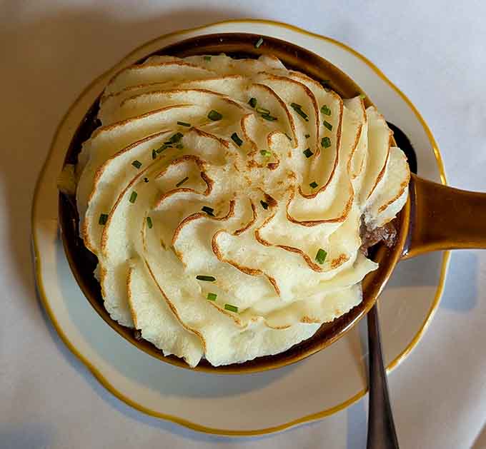 Shepherd's Pie topped with swirled mashed potatoes so photogenic, it deserves its own portrait on the historical walls.