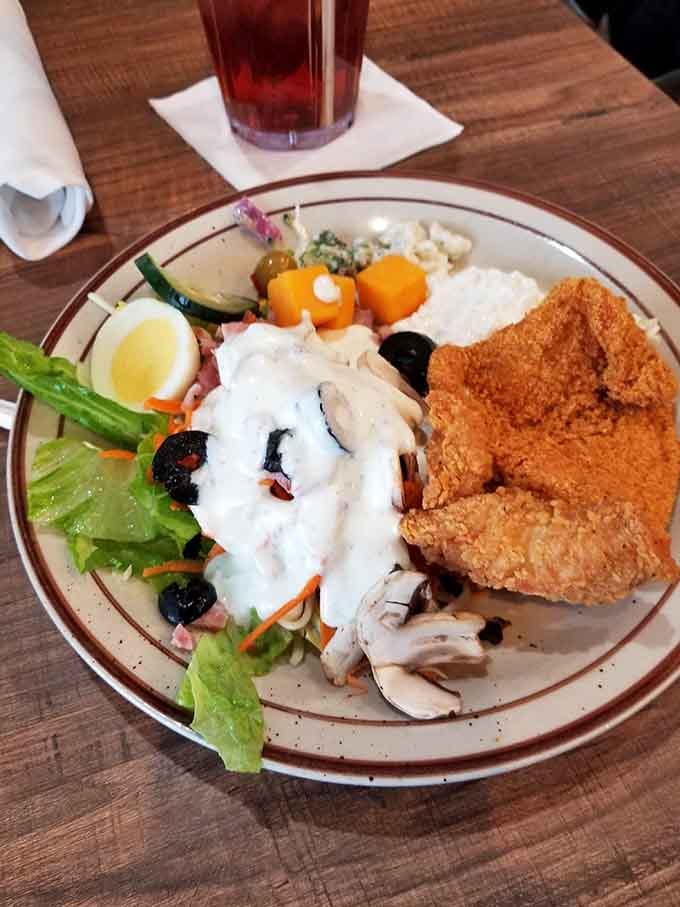 The buffet spread features crispy catfish alongside fresh salad fixings, proving variety really is the spice of dining life.