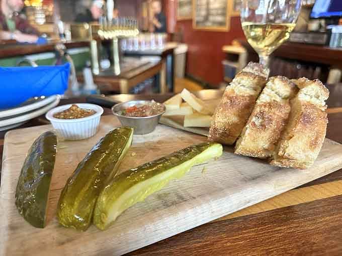 Pickles and pretzel rolls on a wooden board make simplicity look absolutely sophisticated and utterly craveable.