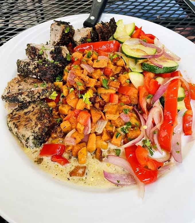 Pork Tenderloin served with colorful vegetables shows what happens when skill meets fresh seasonal ingredients.
