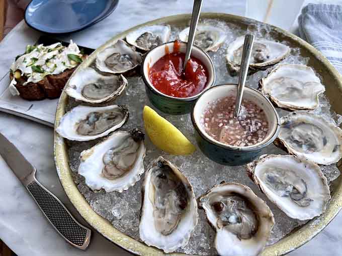 Fresh oysters arrive on ice like edible jewels, each one a briny kiss from the ocean.