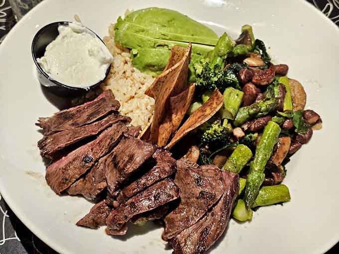 Sliced steak over rice with vegetables proves healthy eating doesn't have to taste like punishment or cardboard.