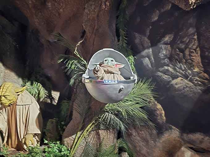 Baby Yoda floats serenely in his pod, proving that cuteness transcends galaxies and wax medium alike.