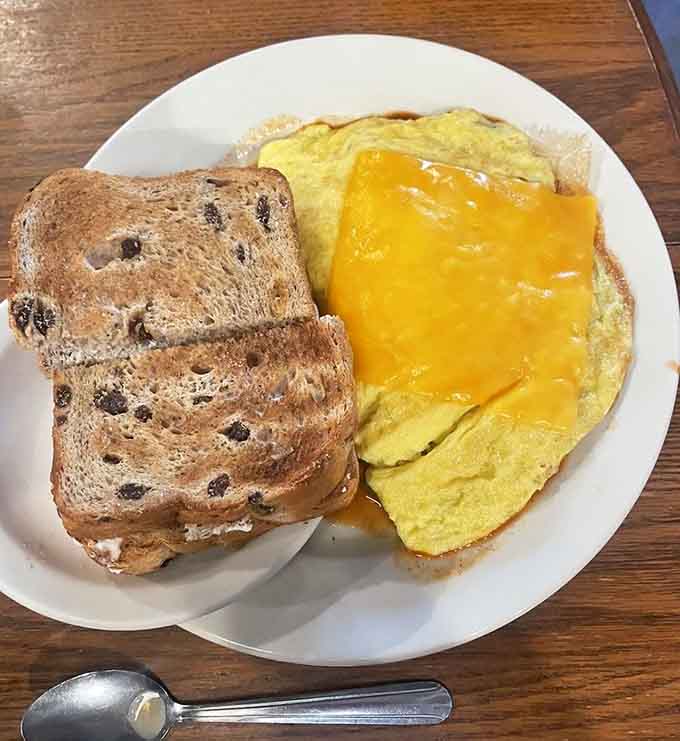 The huevos rancheros omelet arrives with fresh fruit, proving healthy can also mean absolutely delicious and satisfying.
