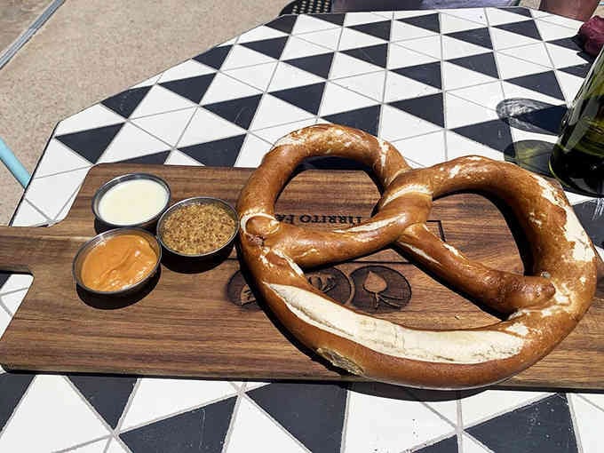 A Bavarian classic served on geometric tiles with three dipping sauces because one sauce is never enough.