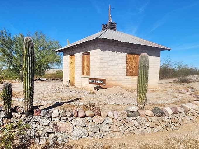 The well house stands as a charming reminder of desert life before air conditioning made everything possible.
