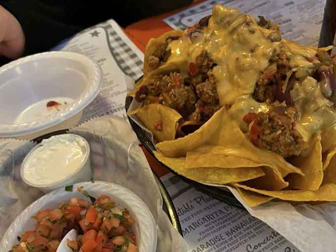 Turkey chili nachos piled so high they defy gravity and possibly several laws of physics too.