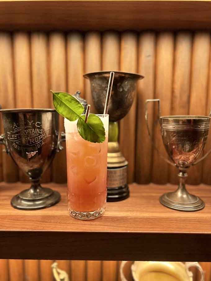 Vintage trophy cups frame your drink like it just won first place in the sophistication Olympics, which it probably did.