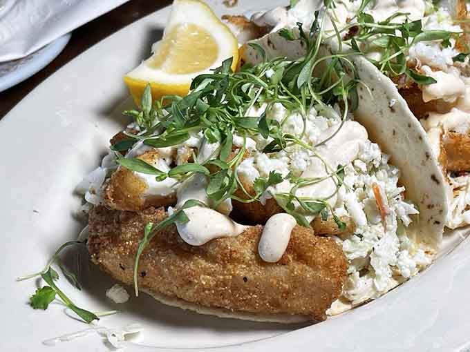 Golden fish tacos topped with fresh greens prove this tavern takes every dish seriously, not just the steaks.