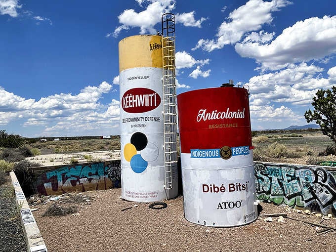 These painted storage tanks now serve as canvases for messages about community, resistance, and indigenous pride.