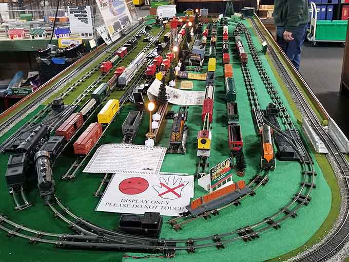 Vintage American Flyer trains lined up like soldiers, each one a piece of childhood nostalgia brought back to life.