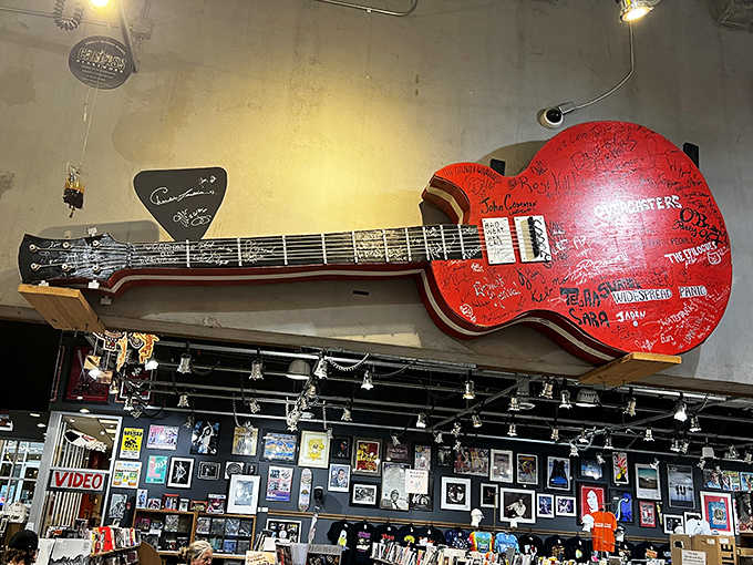 That signed guitar hanging overhead is worth more than your car, and it's not even for sale.