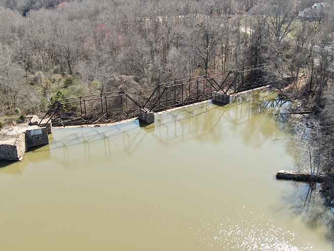 This weathered bridge stands as a rustic monument to engineering from a bygone era.