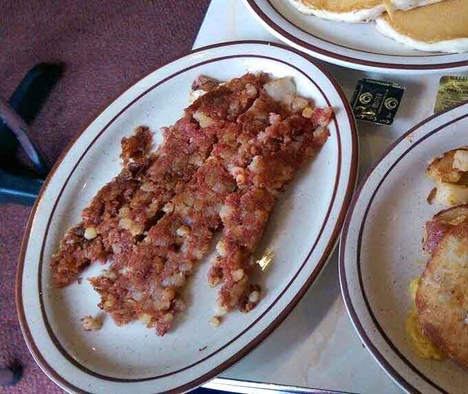 Crispy corned beef hash spread across the plate like edible treasure, the breakfast of champions and wise people.