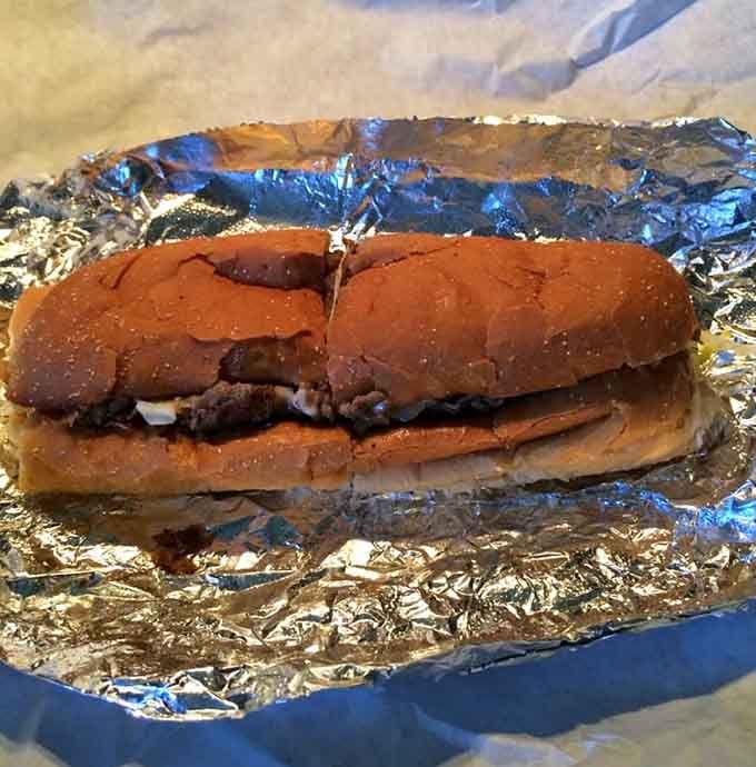 Wrapped in foil like a precious gift, this cheesesteak delivers tender meat and melted cheese in every bite.