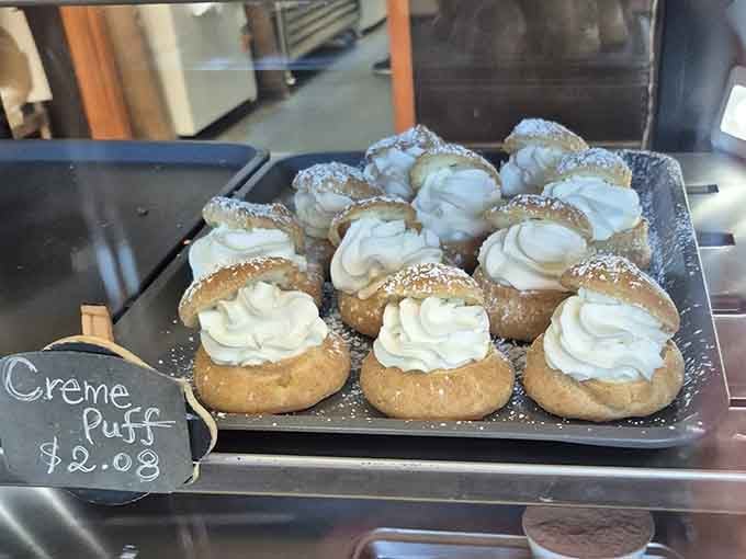 Creme puffs so perfectly piped they look like little clouds of happiness decided to land on a tray.