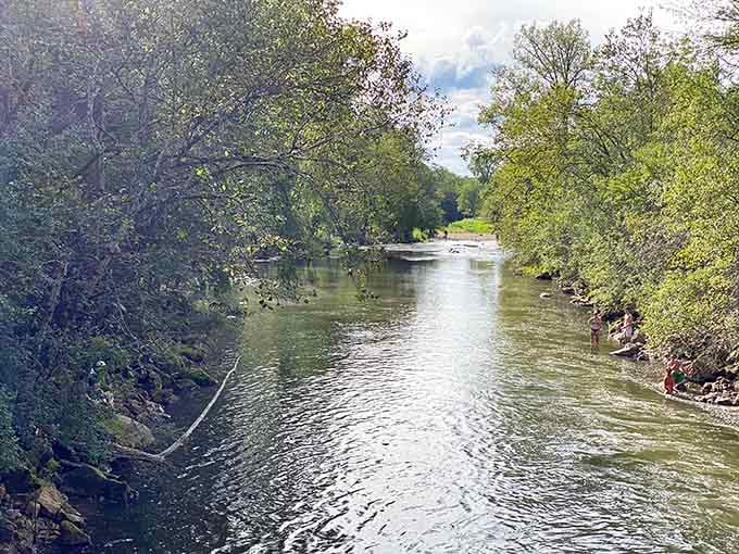 The calm river upstream gives no hint of the dramatic plunge waiting just around the bend.