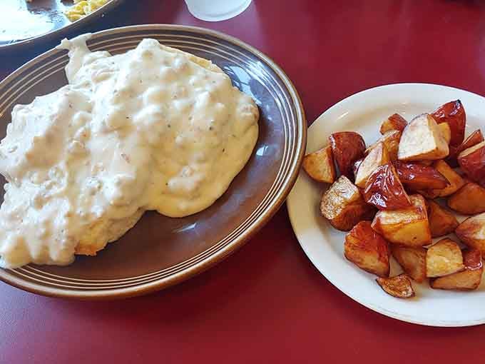 Those golden home fries are the perfect supporting cast to the star of the show: legendary biscuits and gravy.