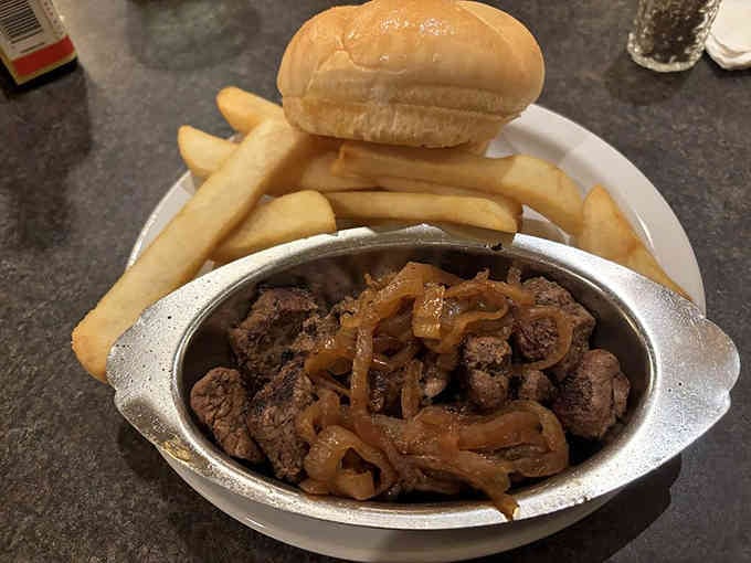 Tender sirloin tips with caramelized onions and fries, proving comfort food doesn't need to be complicated to satisfy.