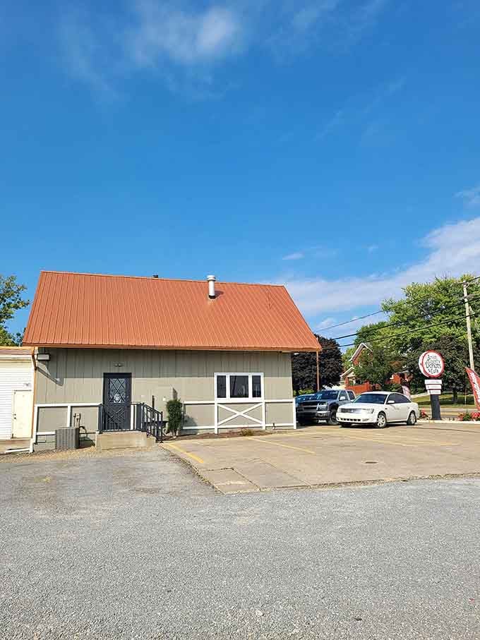 That copper-toned roof catches the sunlight beautifully, standing out like a shiny penny on a summer morning drive.