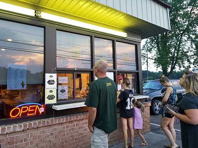 That glowing "OPEN" sign at dusk is like a beacon calling families to gather for sweet, creamy happiness.