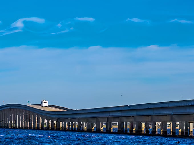 Modern engineering meets natural beauty where this sleek bridge curves across blue water, connecting communities with architectural grace and style.