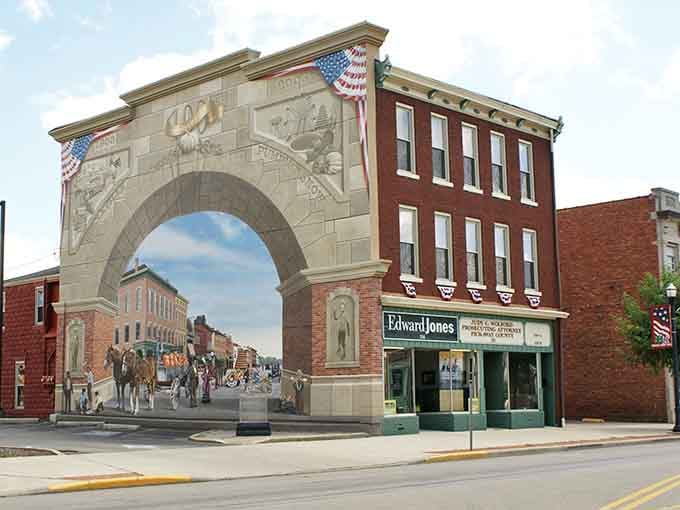 That painted arch mural transforms a downtown corner into living history, celebrating the community's proud heritage beautifully.