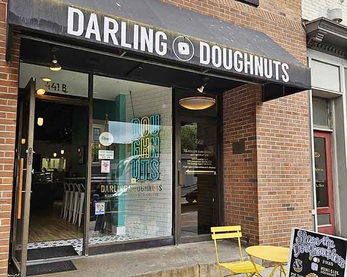 Yellow bistro chairs and brick walls create the kind of inviting streetside scene that makes you want to linger forever.