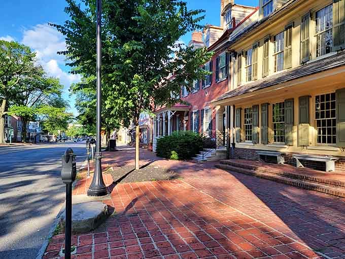 Brick sidewalks and colonial-era buildings bathed in golden light remind us why preservation matters so deeply.