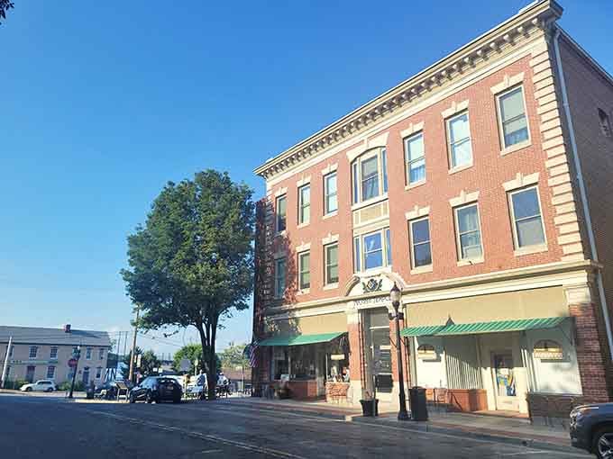 Morning light illuminates the detailed cornices and green awnings that give this street its timeless character.