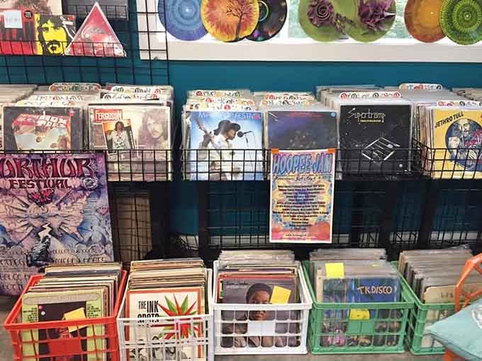 Colorful vinyl records line the walls like a rainbow made entirely of music history and nostalgia.
