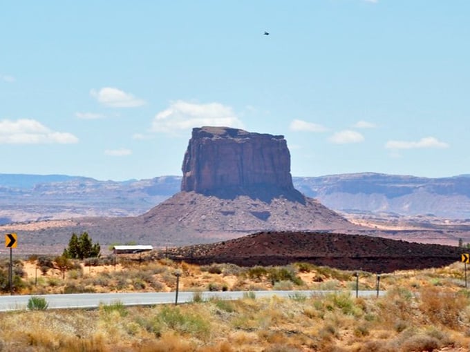 That massive butte rising from the desert floor like a natural skyscraper commands respect from every passing traveler.