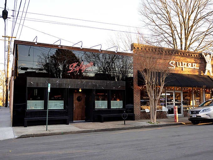 The sleek black exterior and glowing neon script create an atmosphere that's equal parts sophisticated and welcoming.