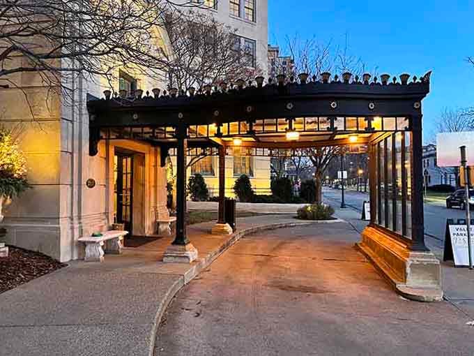 The elegant entrance canopy at dusk creates an atmosphere that whispers "special evening" before you even step inside.