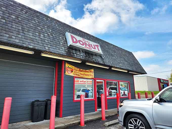 The dark exterior with bright red accents creates a classic contrast that practically shouts "fresh donuts here, folks!"