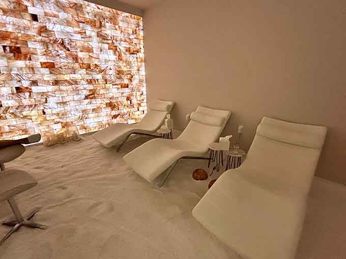 Clean white loungers face a spectacular wall of backlit Himalayan salt&mdash;minimalist design meets maximum relaxation here.