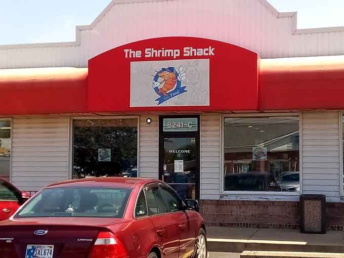 That cartoon shrimp mascot bursting through the sign looks happier than most people on their best vacation day ever.