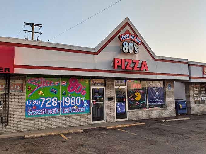 That electric neon storefront practically begs you to grab a slice while humming your favorite Duran Duran tune.