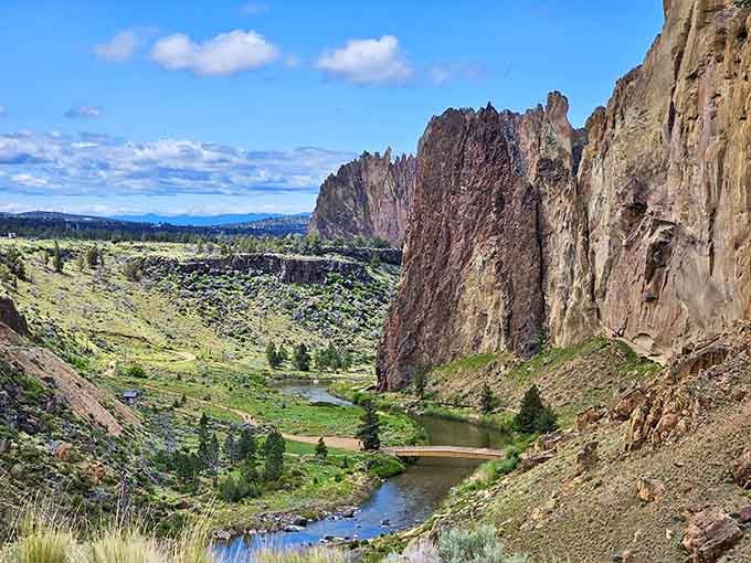 The Crooked River winds through towering volcanic cliffs that glow orange and red like a desert sunset.