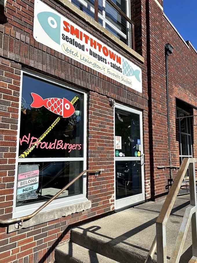 The retro fish artwork and hand-painted signs give this brick storefront genuine character that chain restaurants can't replicate.