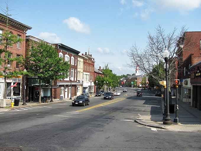 Classic brick buildings line these peaceful streets where retirement dreams meet affordable reality and genuine community spirit.