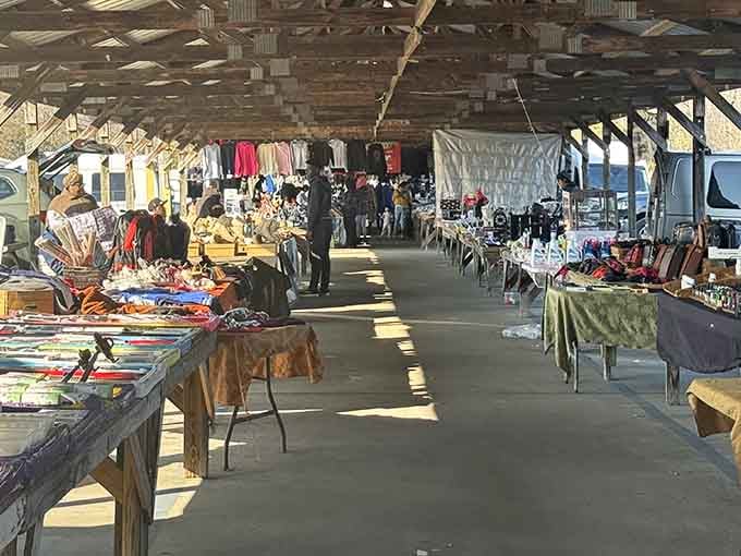 Morning light filters through the pavilion roof, illuminating rows of vendor tables stretching toward the distance.
