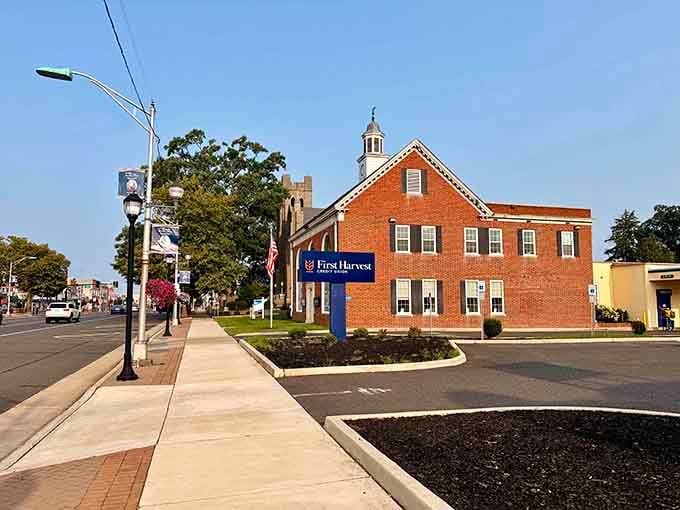 Red brick and white trim frame the entrance to community gatherings, standing solid beneath blue skies and sunshine.
