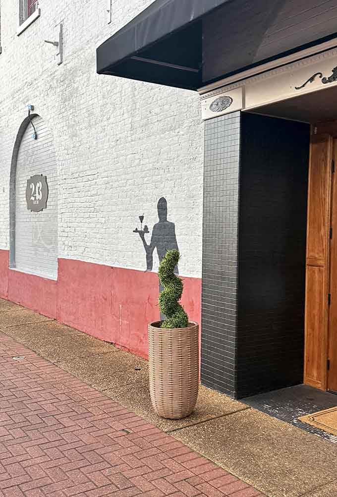 The sophisticated mural and pink accent wall prove this downtown gem balances artistry with serious culinary skill.