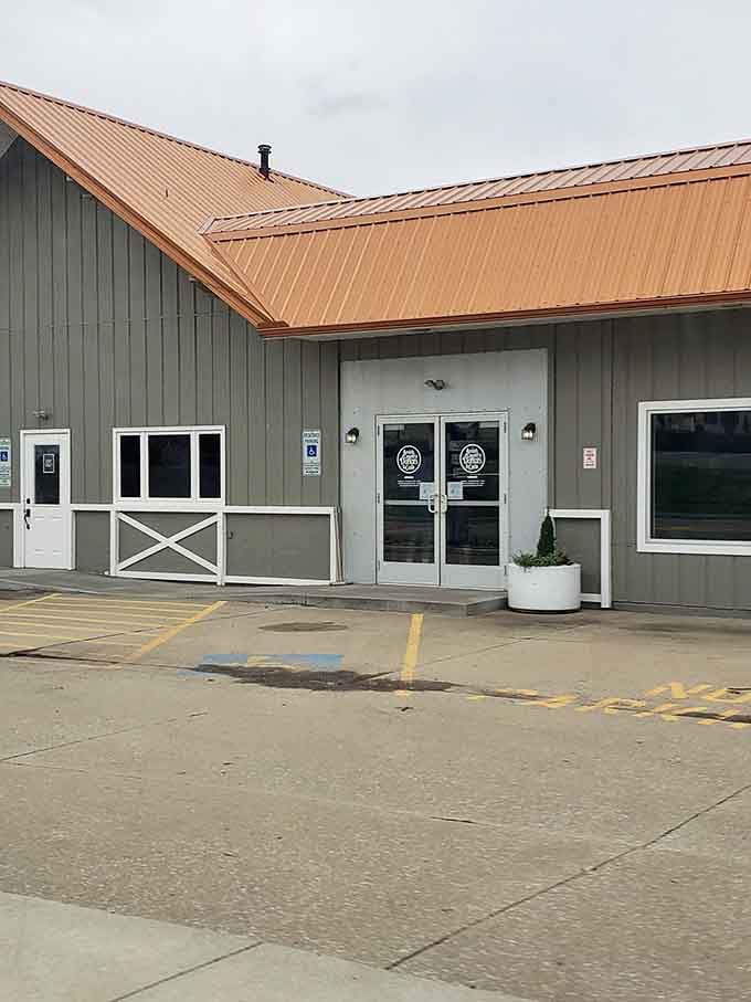 The barn-style architecture with modern touches creates a welcoming blend of country charm and contemporary donut-making excellence inside.